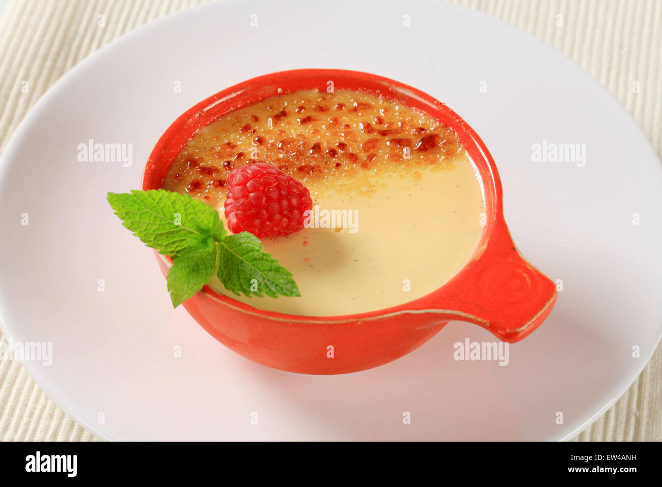 Creme brulee in a red dish Stock Photo - Alamy