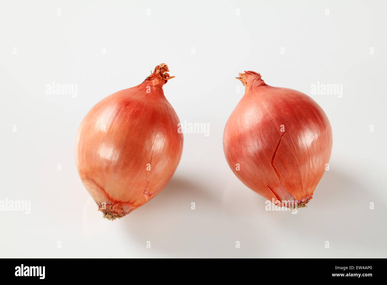 Raw red onions - studio shot Stock Photo - Alamy