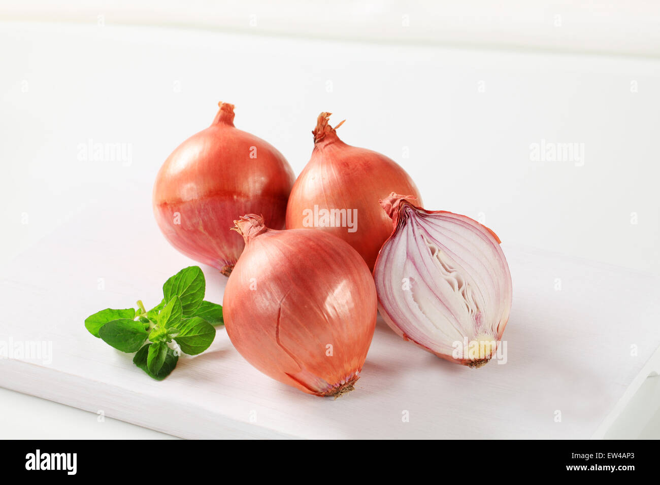 Raw red onions - studio shot Stock Photo - Alamy