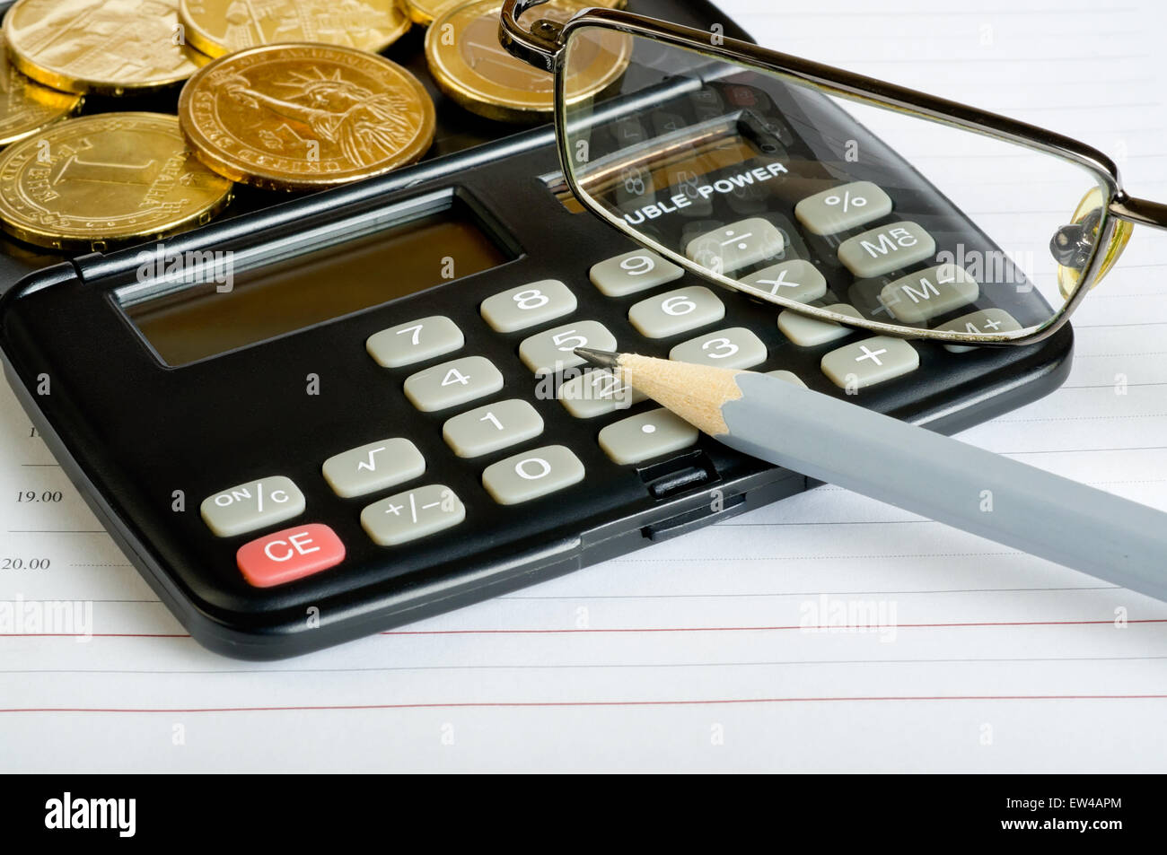 Calculator, glasses, coins and pencil on a sheet of diary Stock Photo ...