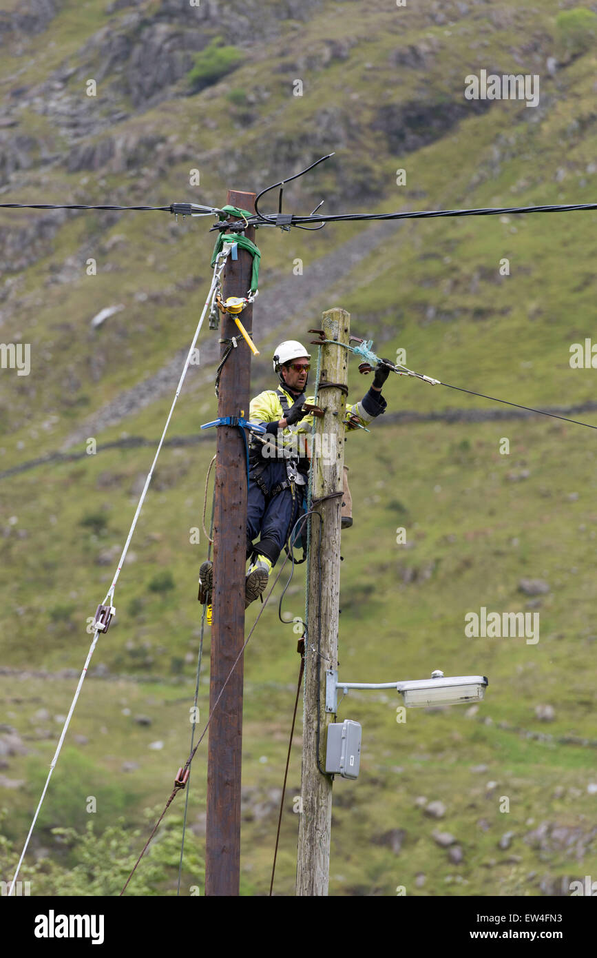 An engineer carries out maintenance on a electricity utility pole in ...