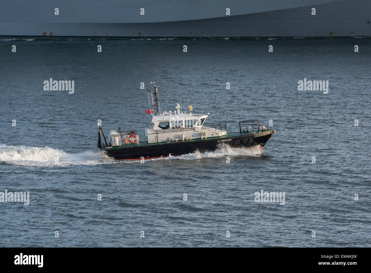 Small boat in front of large warship, HMS ocean Stock Photo - Alamy