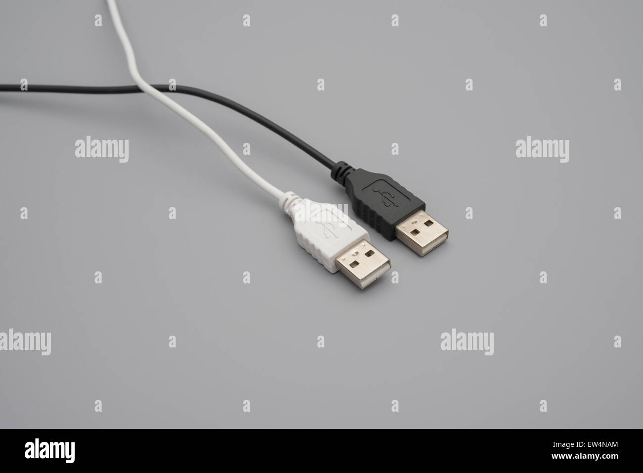 black and white usb cables on grey background Stock Photo - Alamy