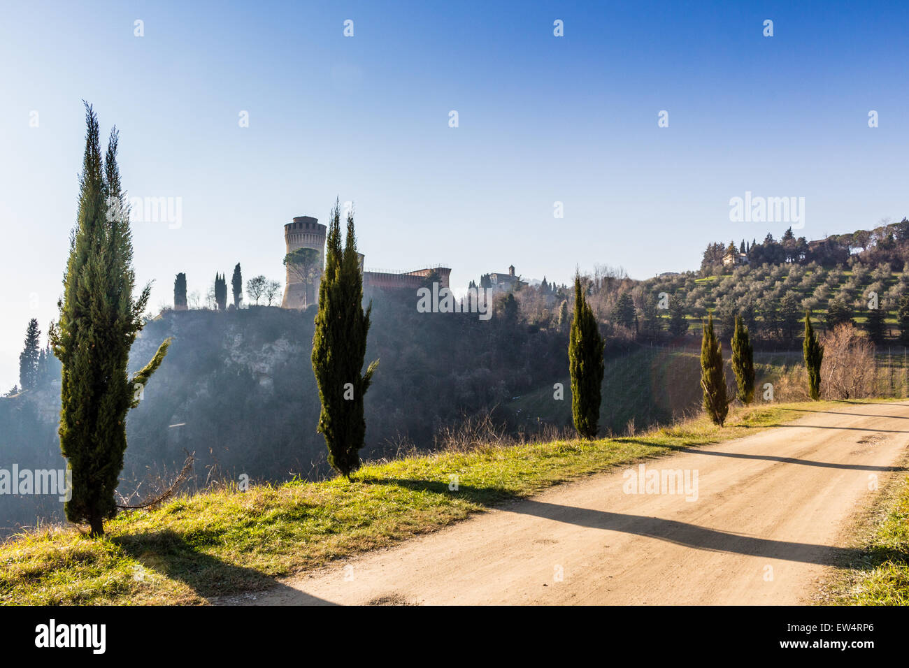 Cypress trees bordering a walk path to a medieval fortress and a ...