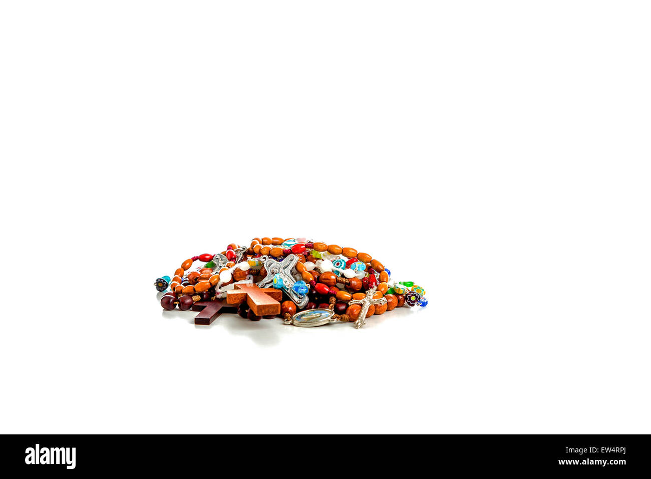 Some Rosary beads piled messily. They are different for colors, shapes ...