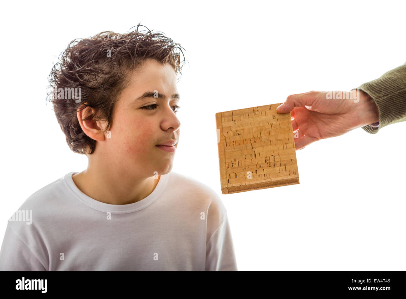 A Caucasian boy smiles receiving a blank brown cork book from adult ...