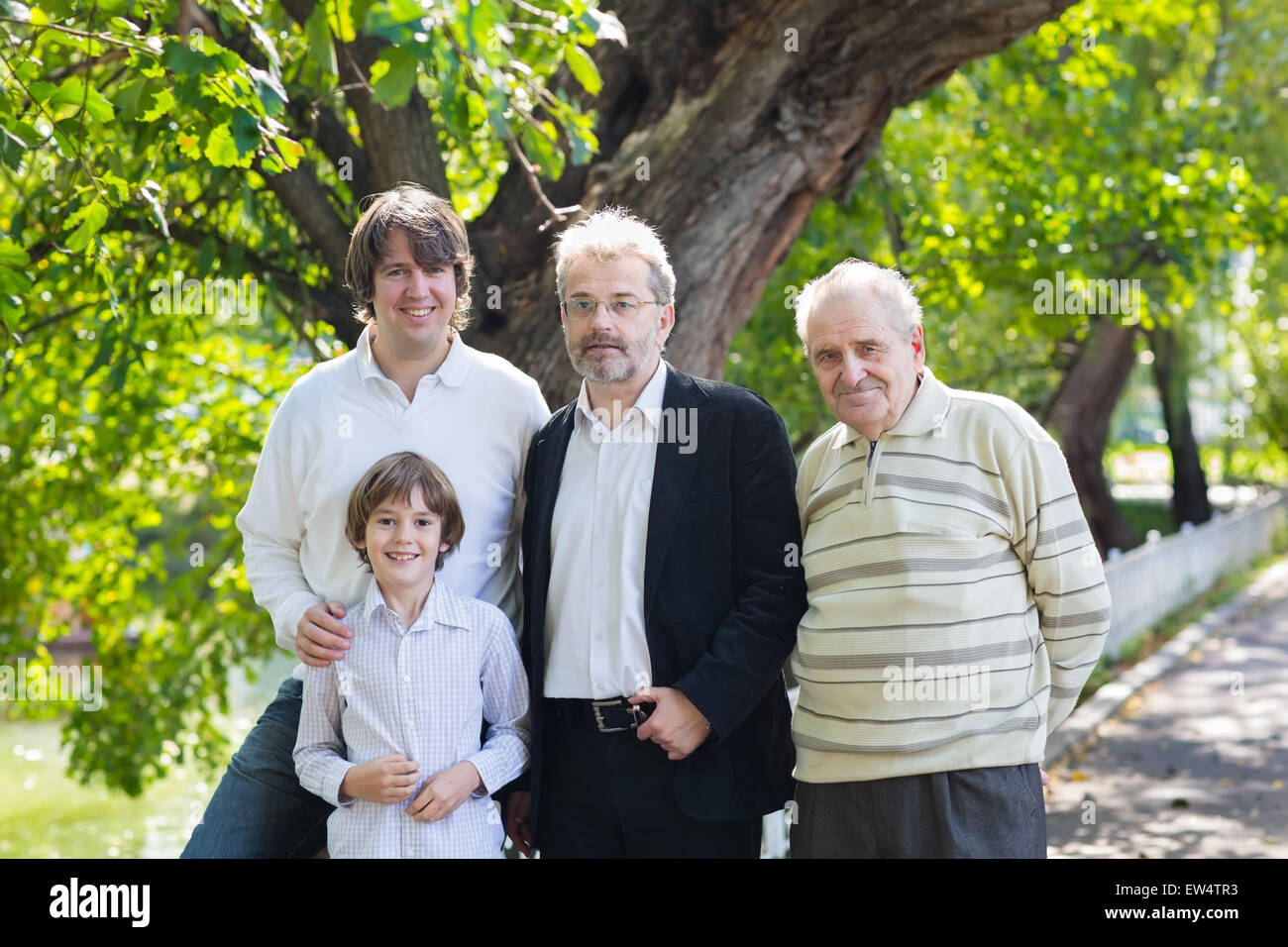 Four generations of men and a baby girl in a park Stock Photo - Alamy