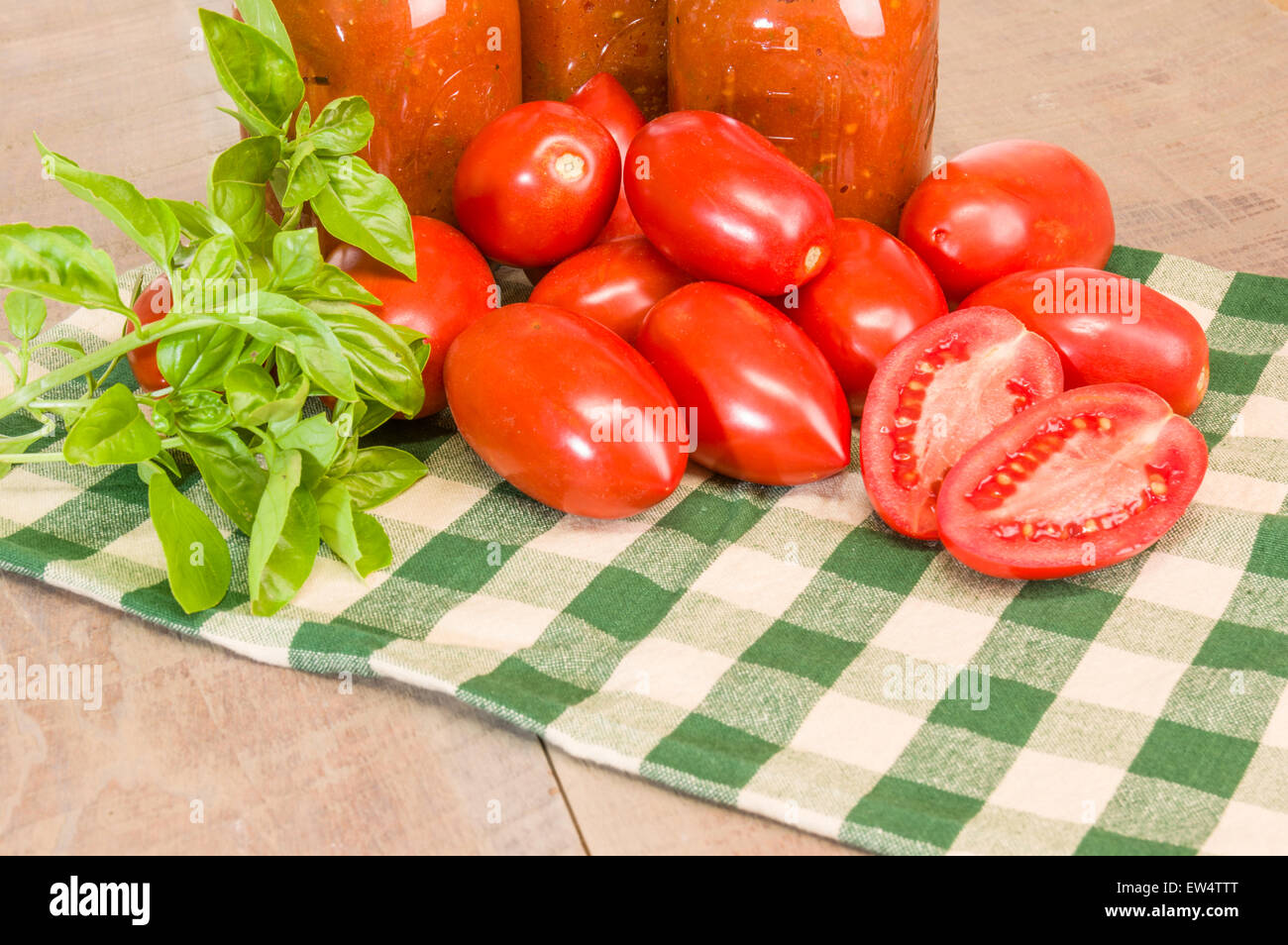 Jars of tomato sauce with fresh basil and red paste tomatoes Stock ...