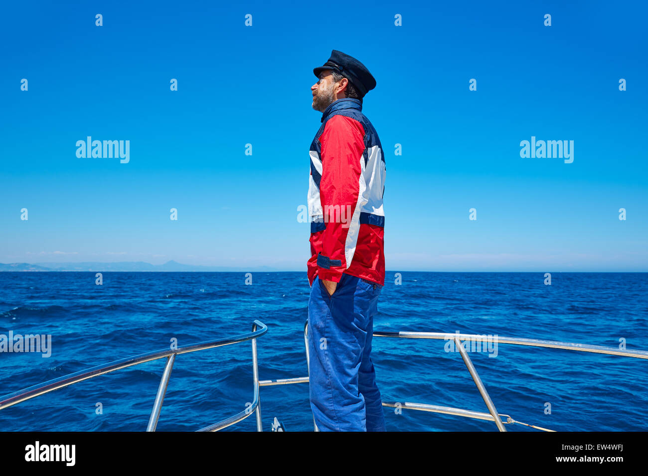 Beard sailor man sailing sea ocean in a boat with captain cap looking ...