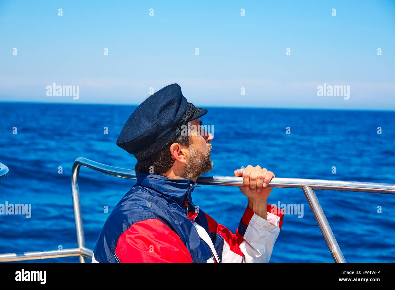Beard sailor man sailing sea ocean in a boat with captain cap looking ...