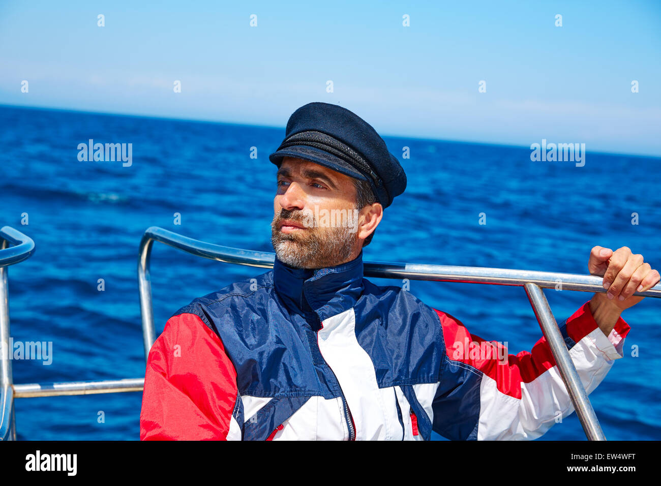 Beard sailor man sailing sea ocean in a boat with captain cap looking ...