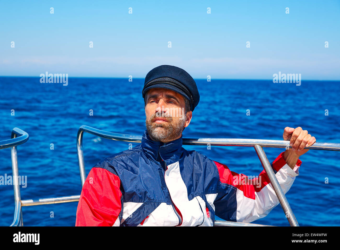 Beard sailor man sailing sea ocean in a boat with captain cap looking ...