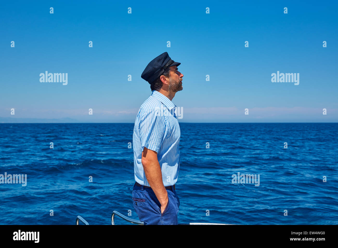Beard sailor man sailing sea ocean in a boat with captain cap looking ...