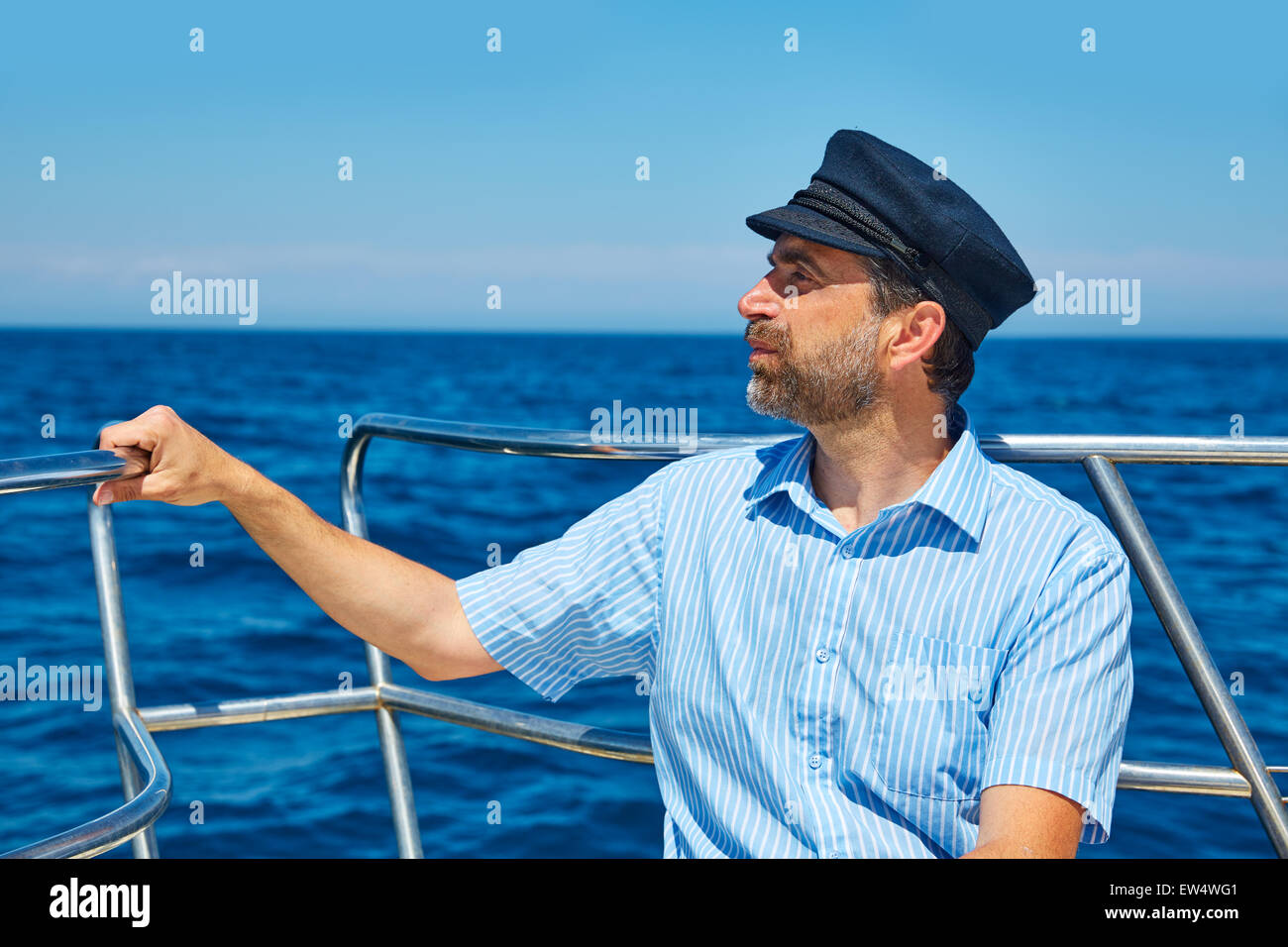 Beard sailor man sailing sea ocean in a boat with captain cap looking ...