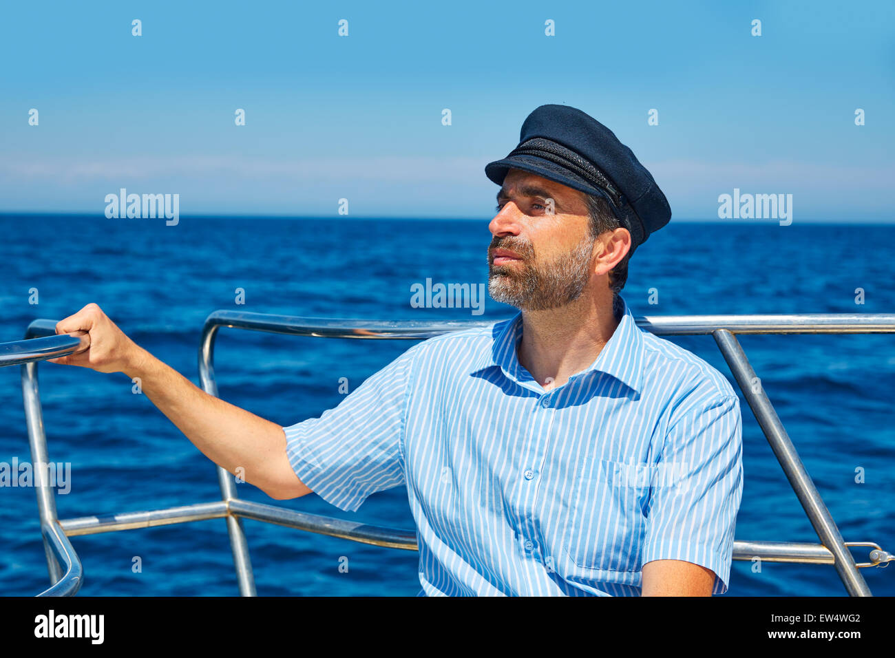 Beard sailor man sailing sea ocean in a boat with captain cap looking ...