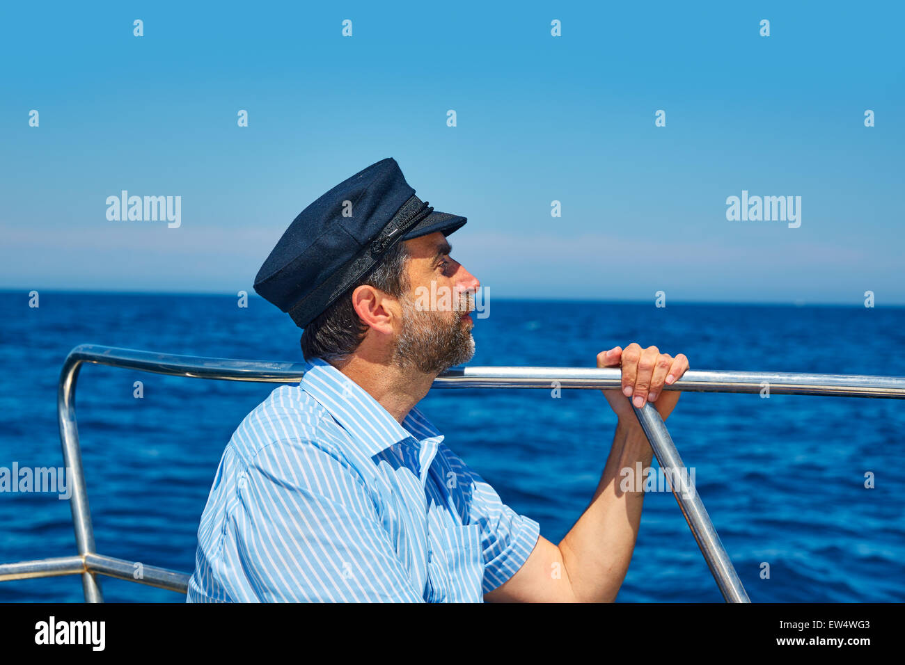 Beard sailor man sailing sea ocean in a boat with captain cap looking ...