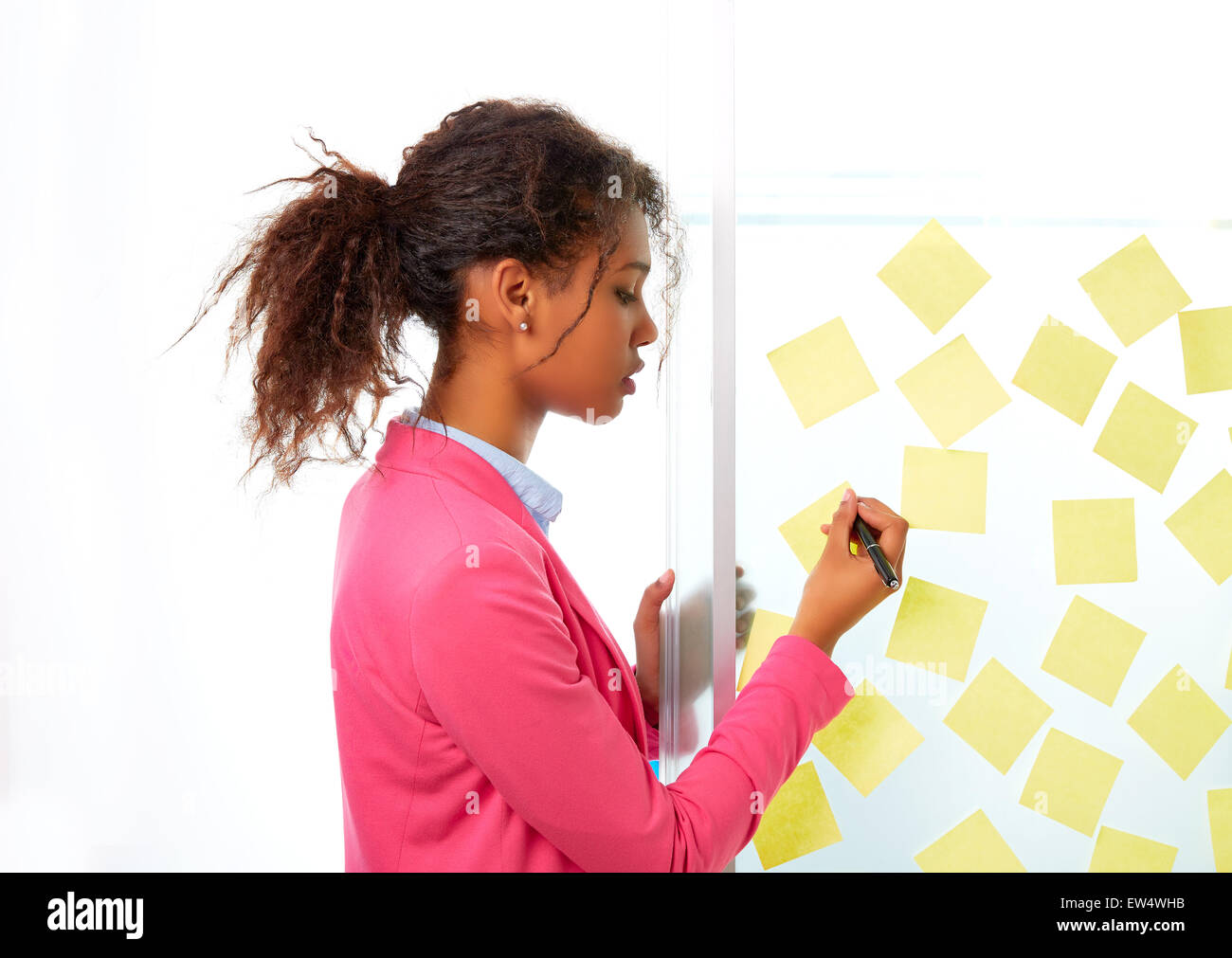 African ethnic executive with stickers in office young business woman ...