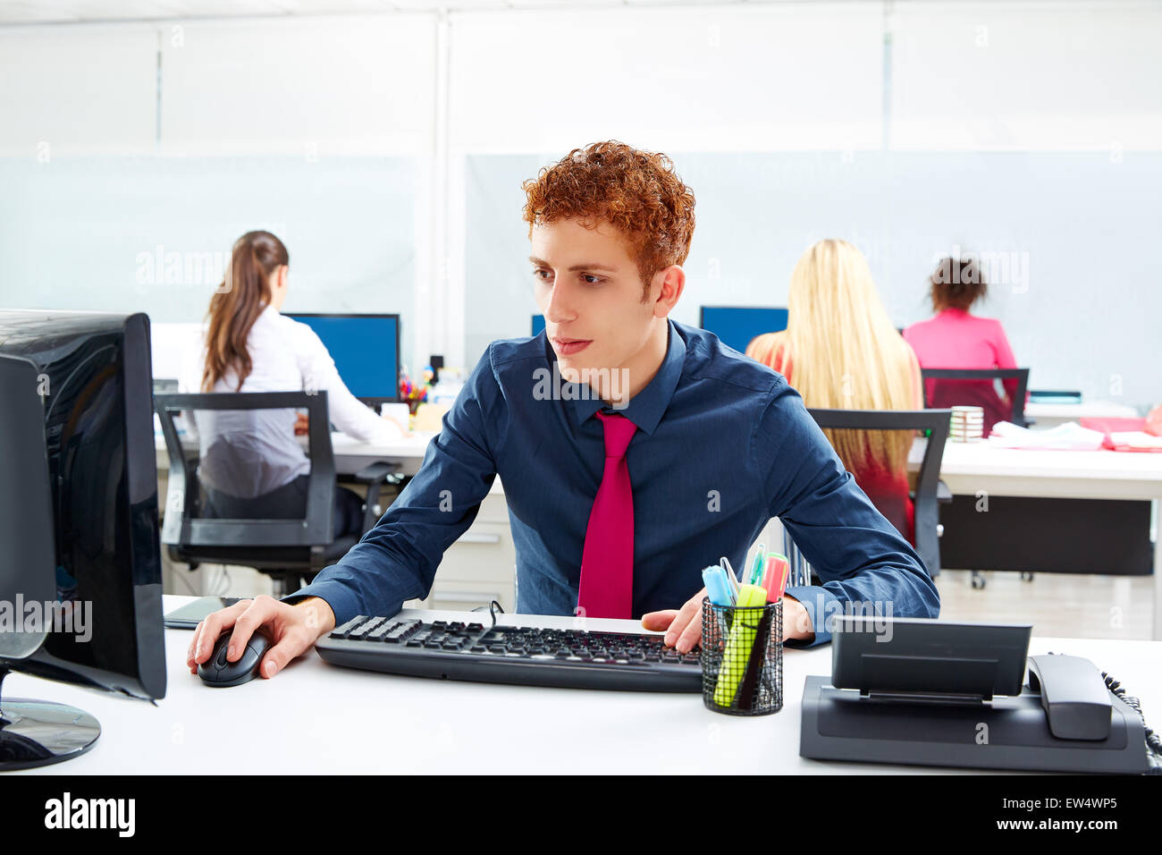 Executive young businessman working computer at offcie desk Stock Photo ...