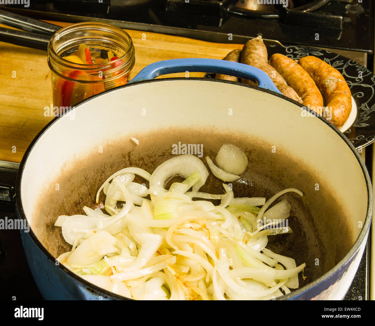 Sliced white onions being cooked on the stove in a pan Stock Photo - Alamy