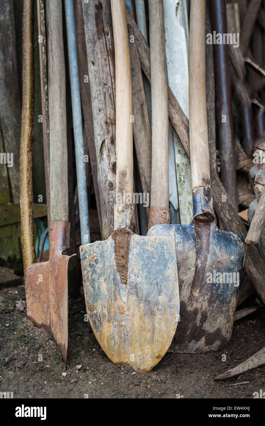 Used and worn gardening tools in a shed, waiting spring farm work Stock ...