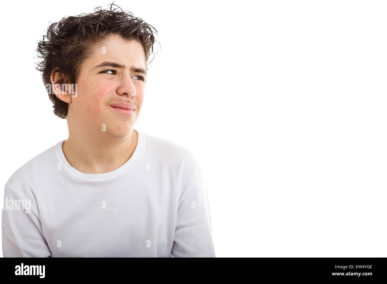 A Hispanic boy with dried lips takes a worried look to to the right ...
