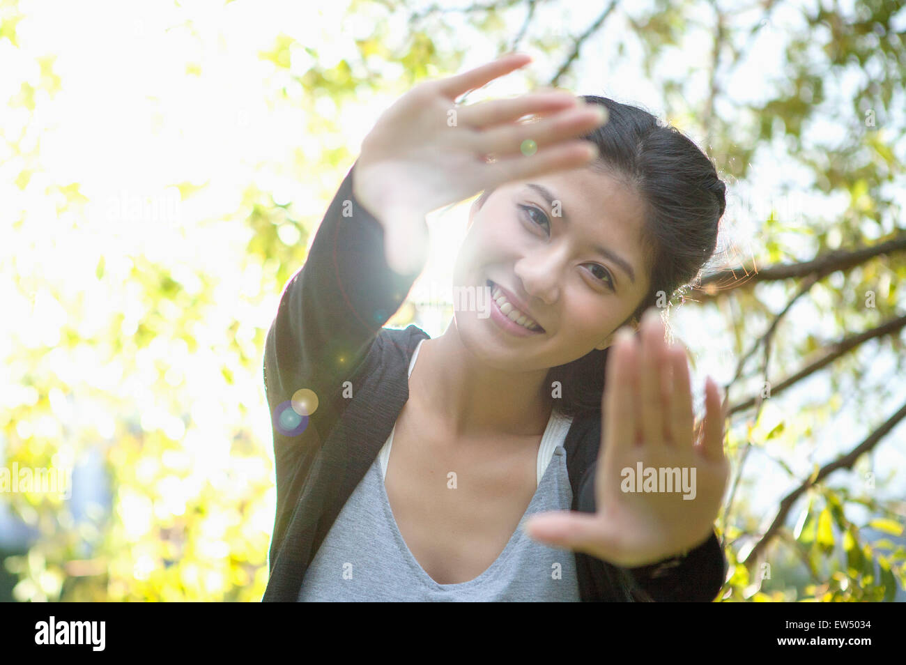 Young woman reaching hands and smiling at the camera Stock Photo - Alamy
