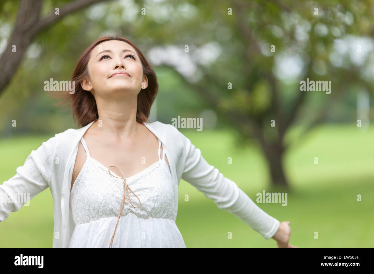 Woman with arms up side view hi-res stock photography and images - Alamy