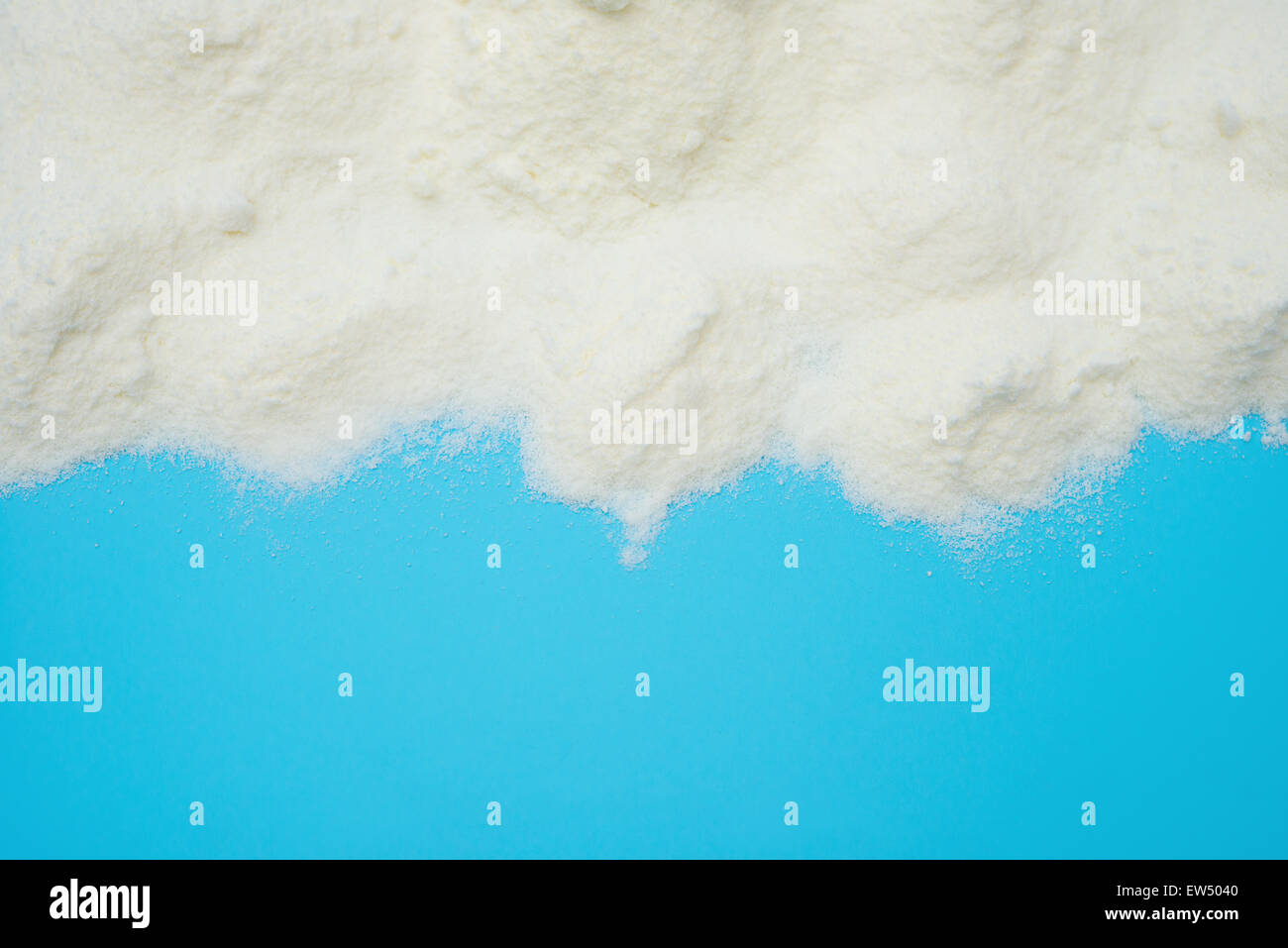 powdered milk on blue background with copy space Stock Photo - Alamy