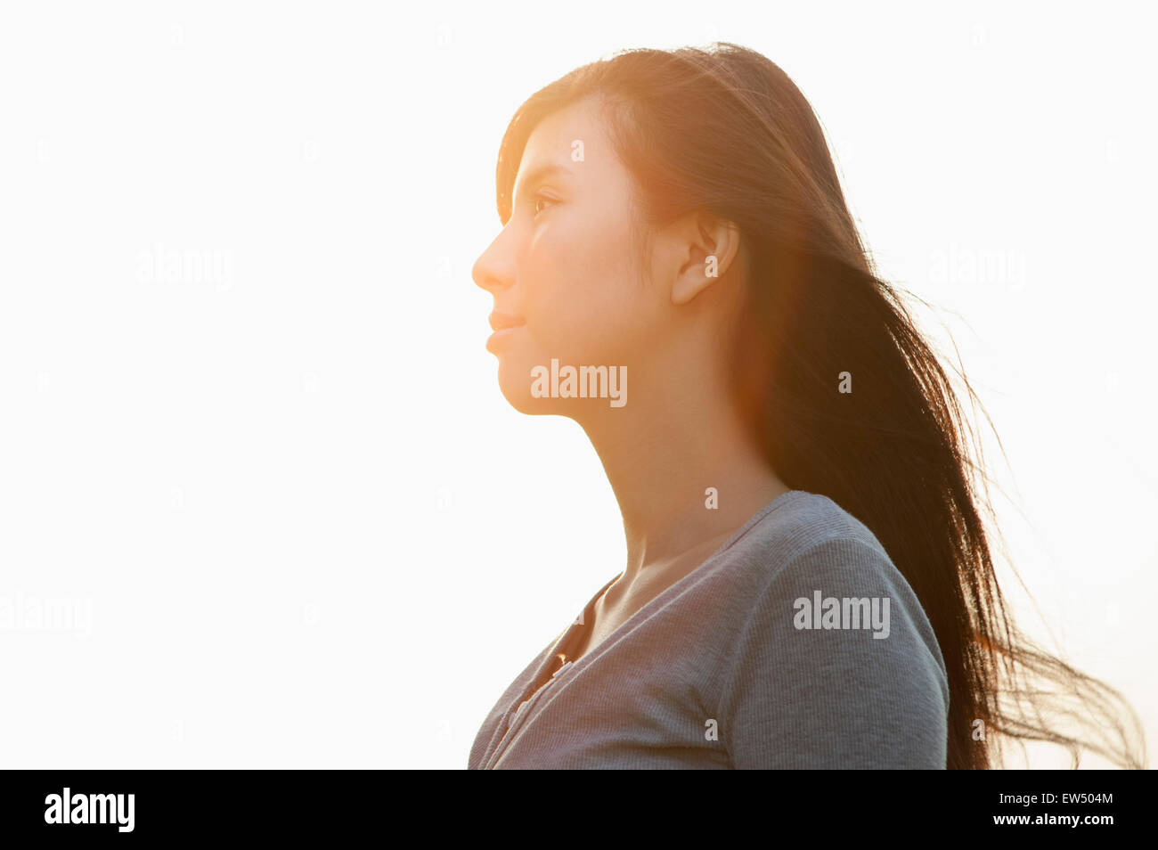 Young woman looking away with smile Stock Photo - Alamy