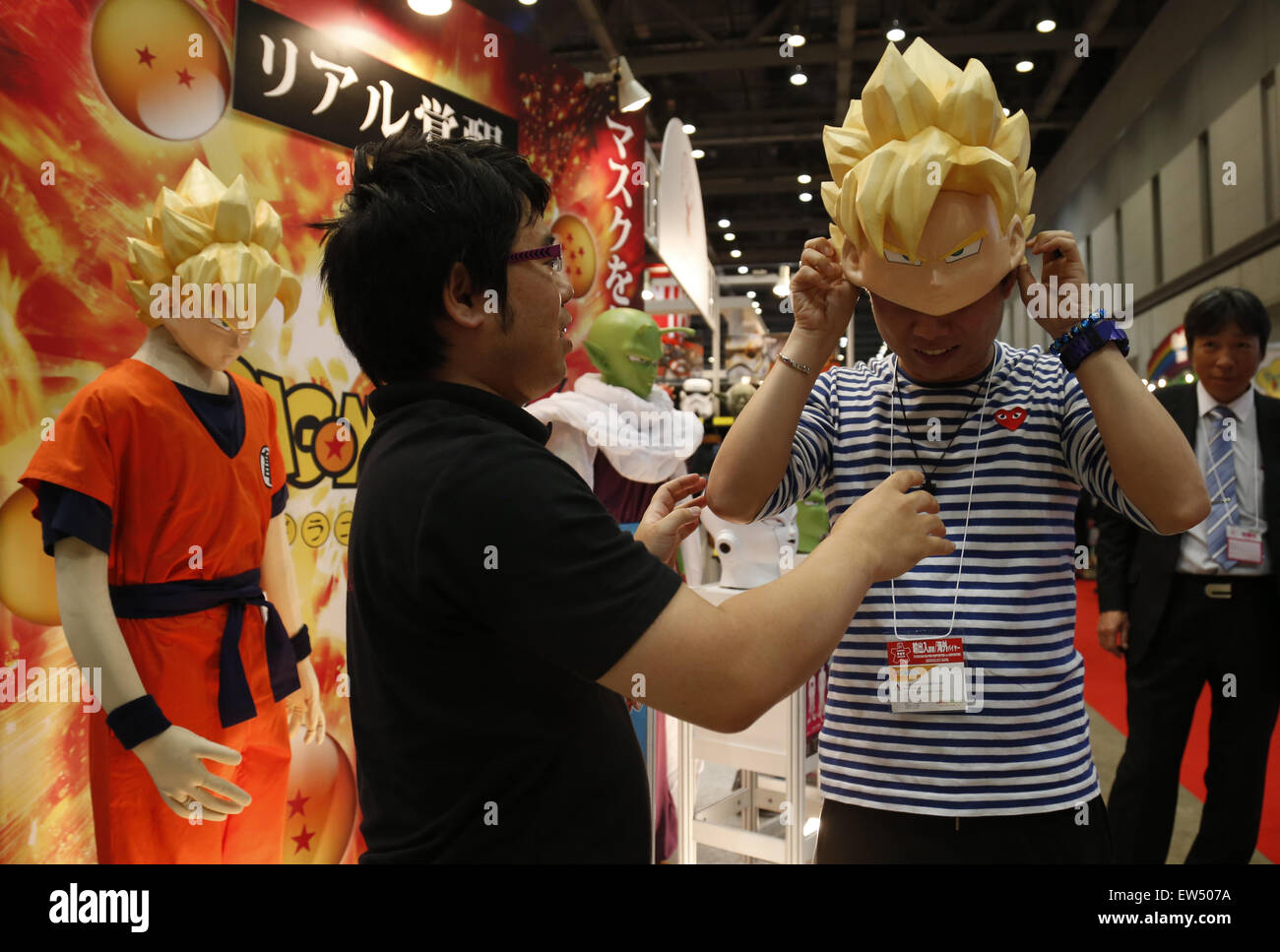 Tokyo, Japan. 18th June, 2015. A businessman tries on the mask of ...