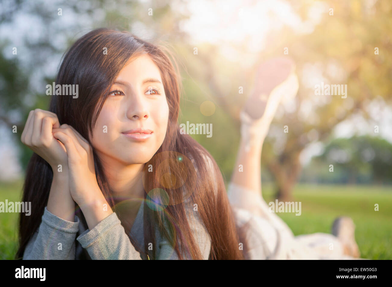 Young woman lying down long hair hi-res stock photography and images ...