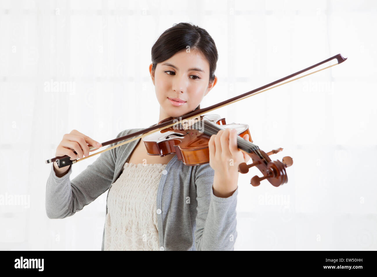 Beautiful woman playing violin hi-res stock photography and images - Alamy