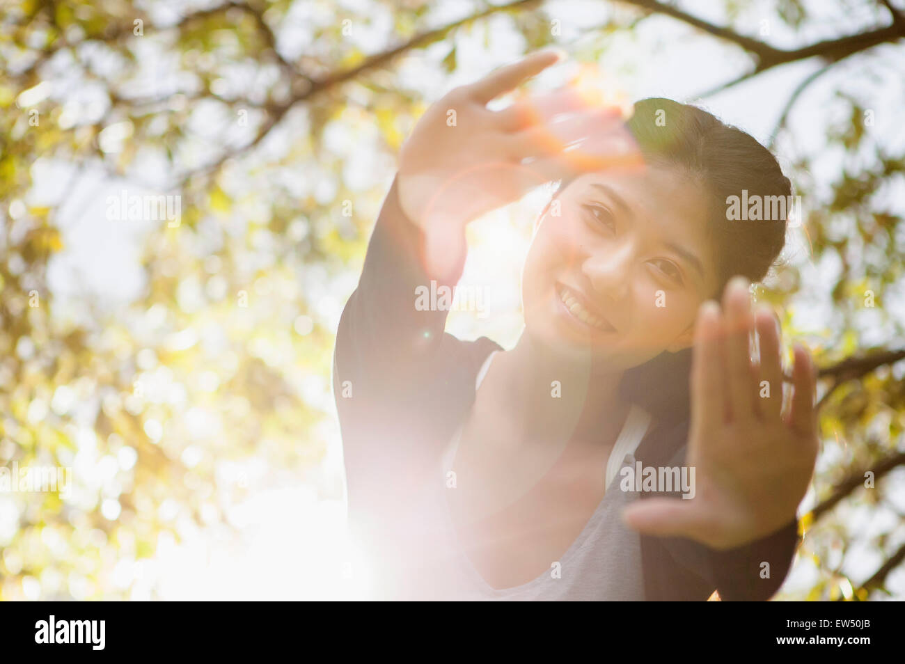 Young woman smiling at the camera and reaching hands Stock Photo - Alamy
