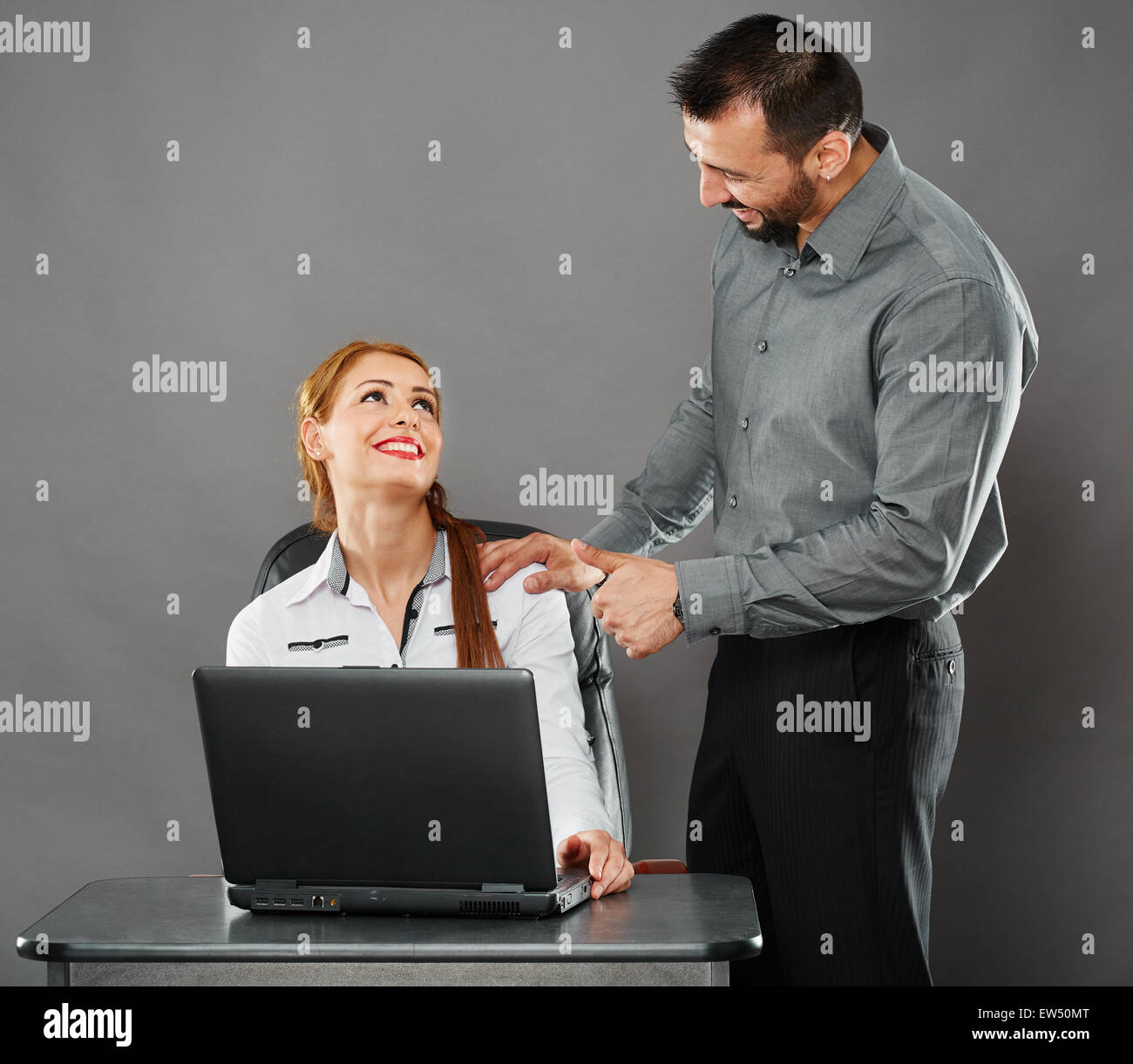 Happy boss impressed with the performance of his female employee ...