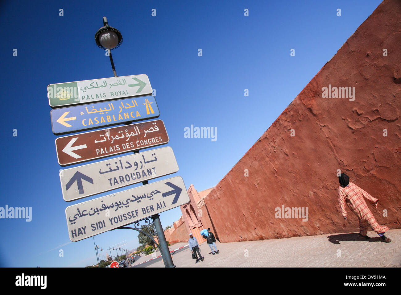 Signpost alongside large wall near the Royal Palace in Marrakesh ...