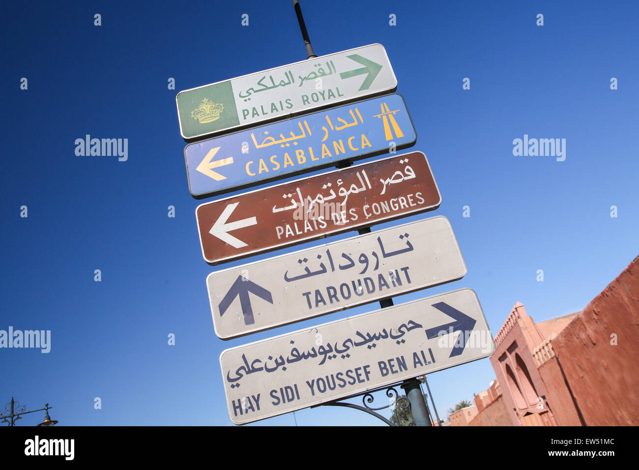 Signpost alongside large wall near the Royal Palace in Marrakesh ...
