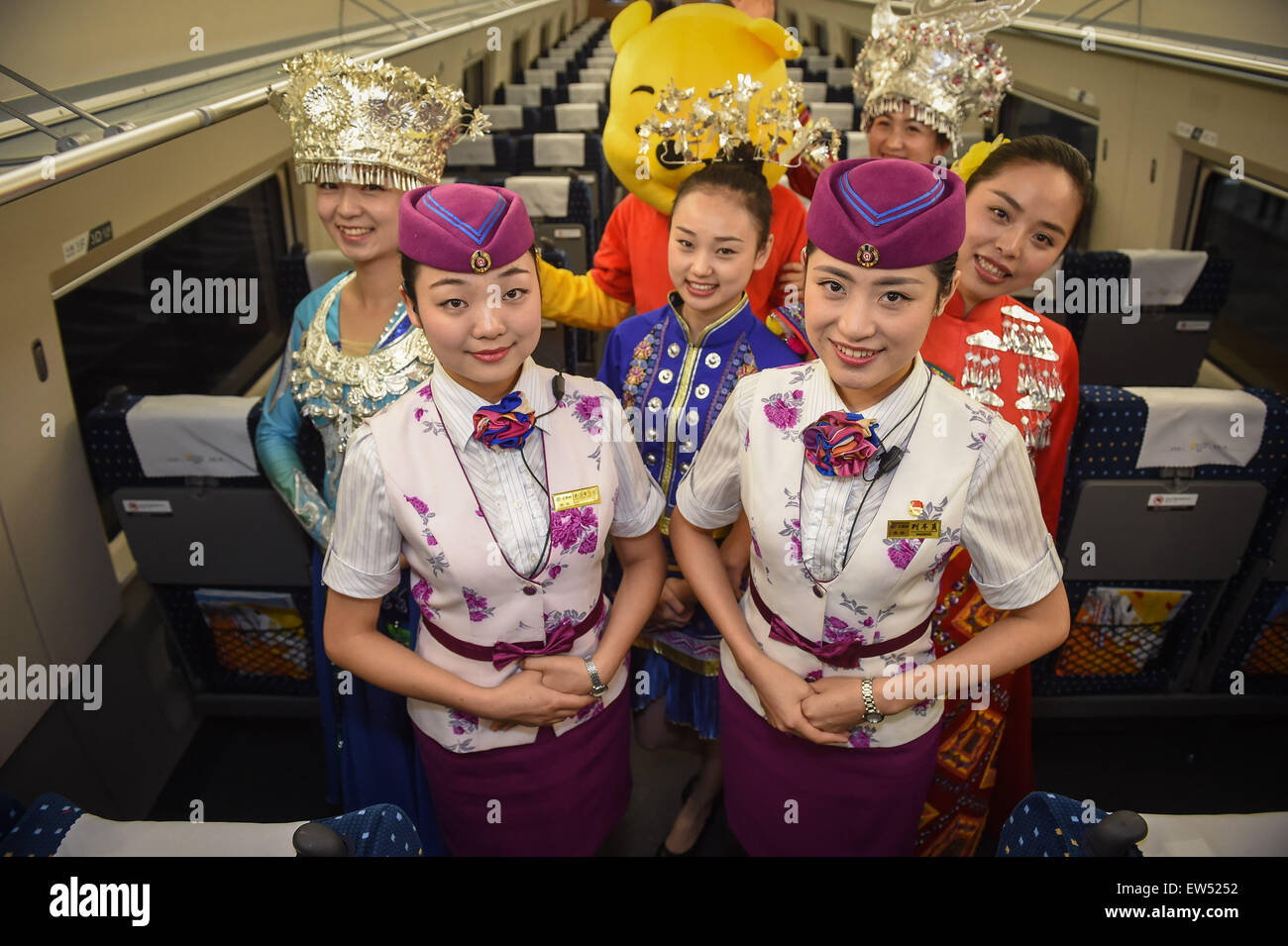 Guizhou, China. 18th June, 2015. Train attendants wearing Miao and ...