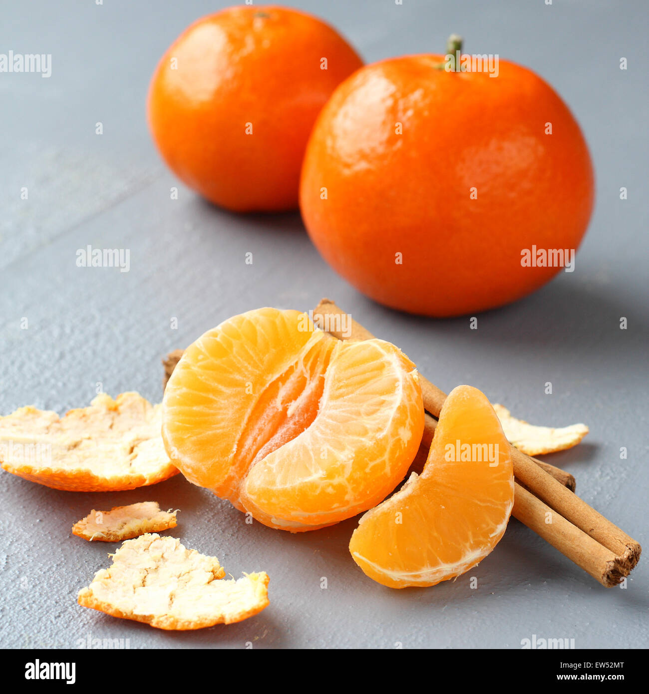 Open fresh mandarin with cinnamon sticks on gray background Stock Photo ...