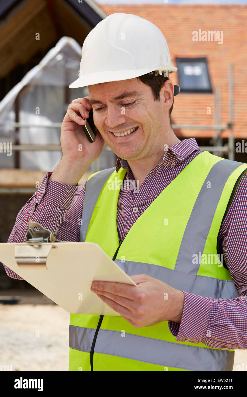 Architect On Building Site Using Mobile Phone Stock Photo - Alamy