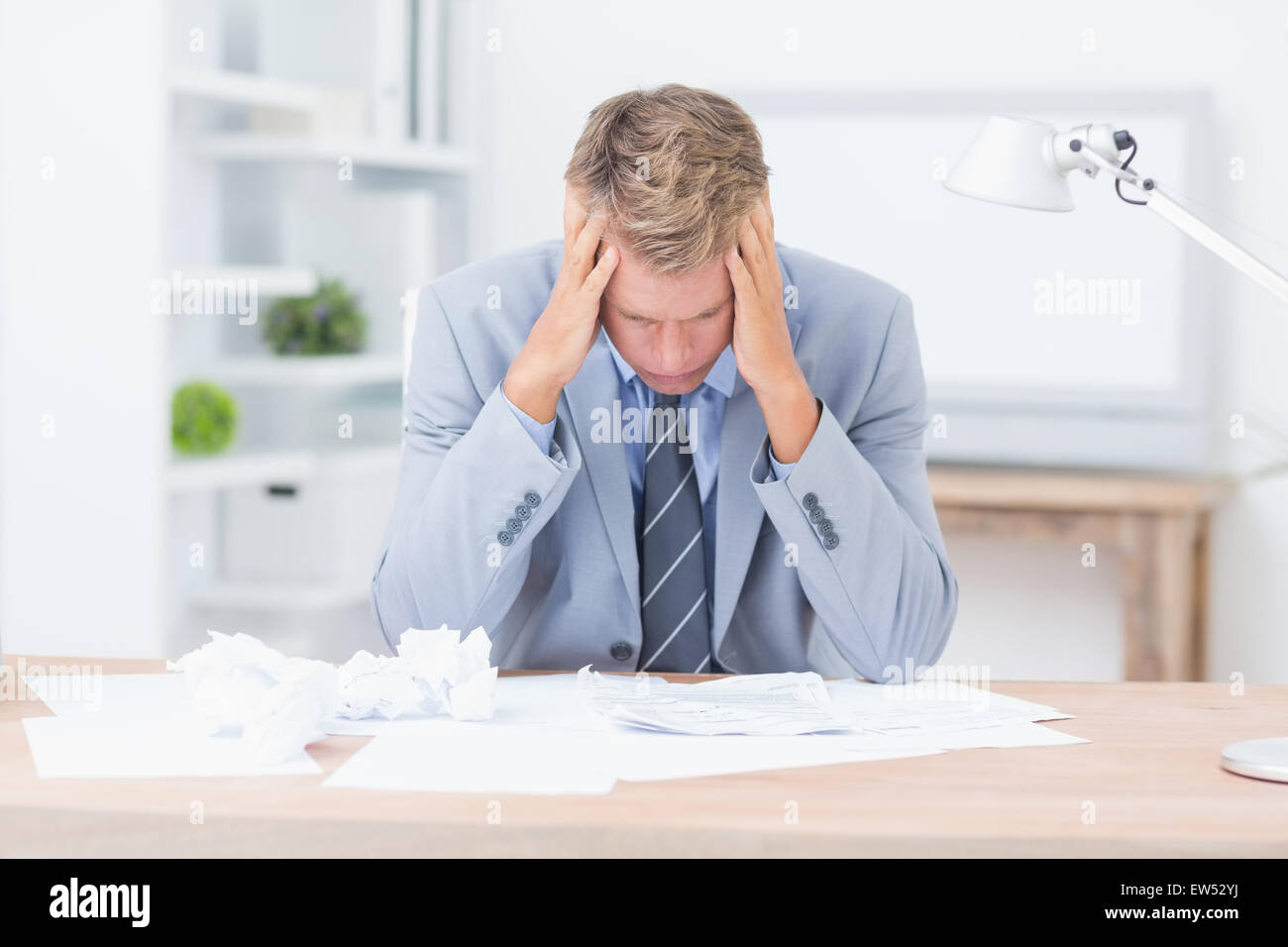 Businessman being depressed by working Stock Photo - Alamy