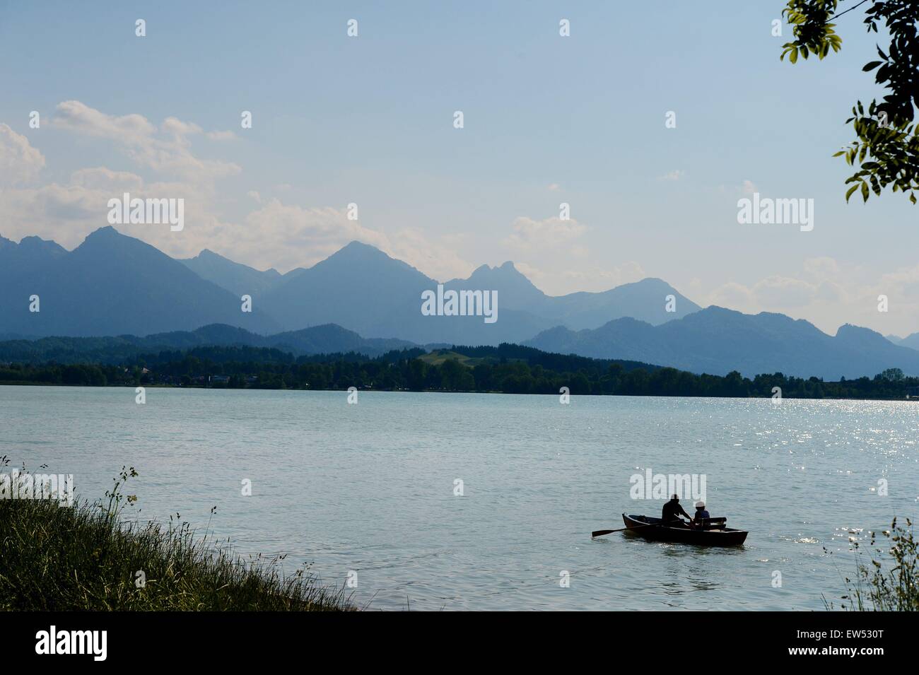 A boat on Lake Forggensee in Bavaria, Germany, near the city of ...