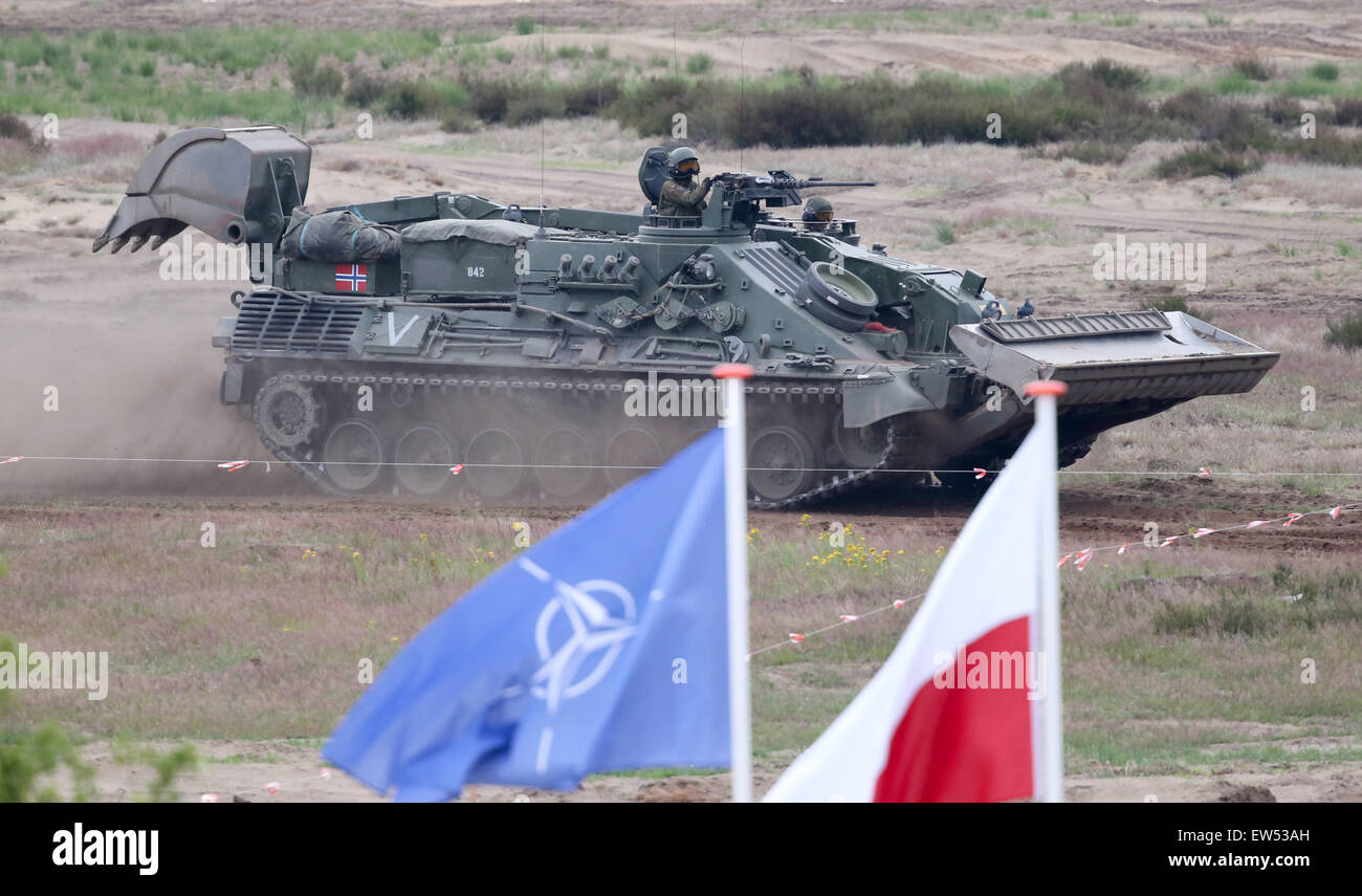 A Norwegian tank dozer rides over the drill grounds before the start of ...