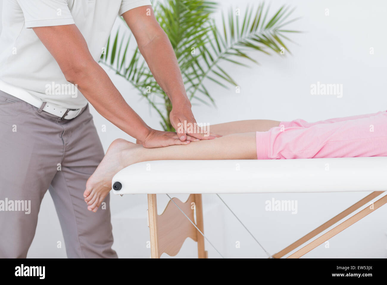 Doctor examining his patient leg Stock Photo - Alamy