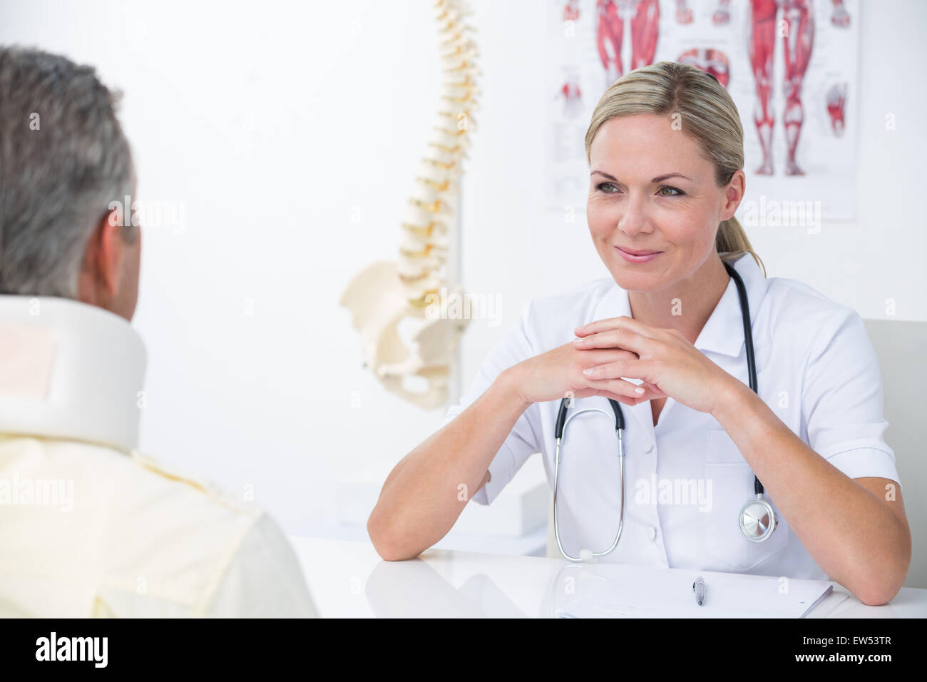 Doctor looking at patient wearing neck brace Stock Photo - Alamy