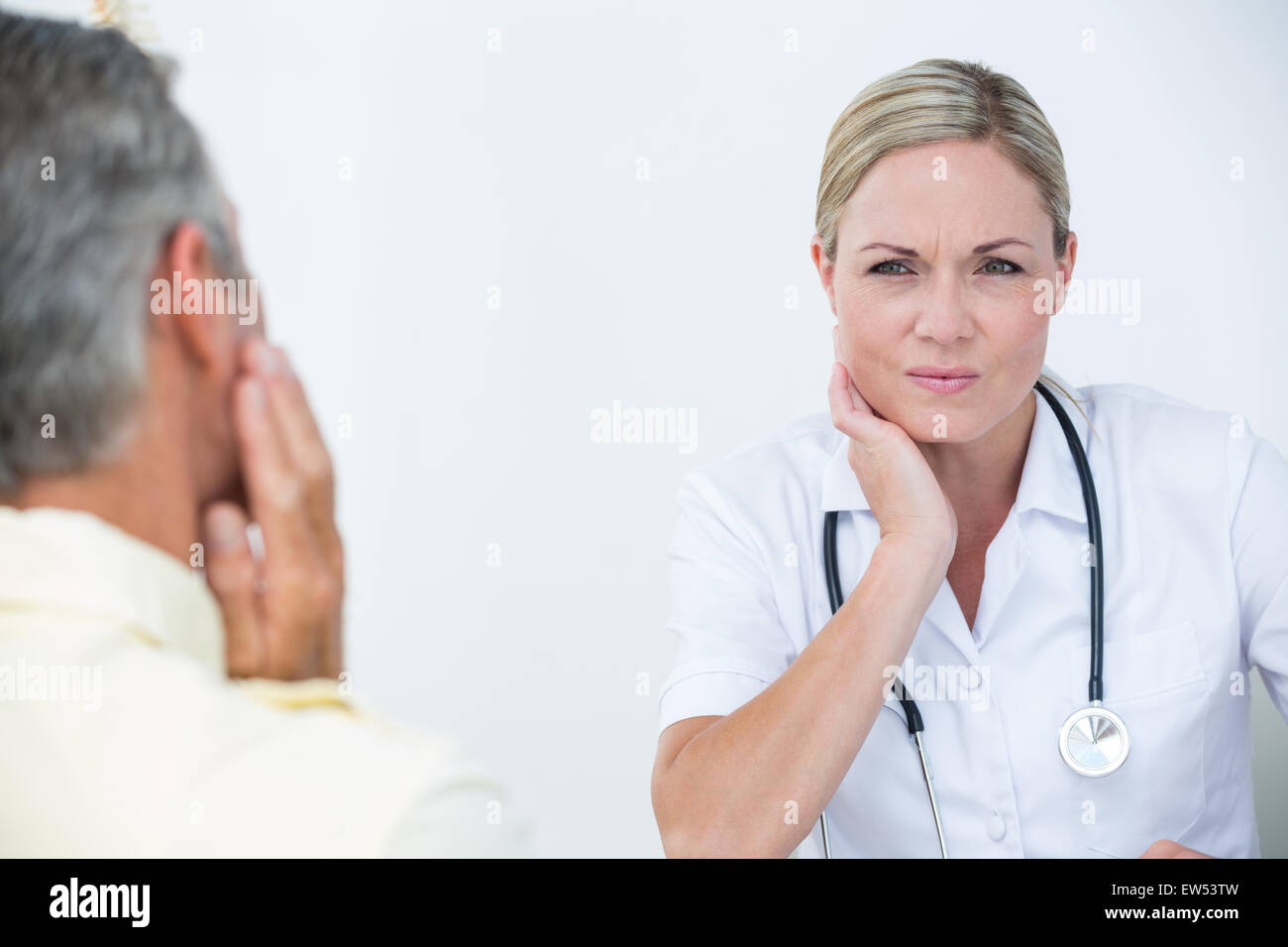 Doctor examining patient with neck ache Stock Photo - Alamy