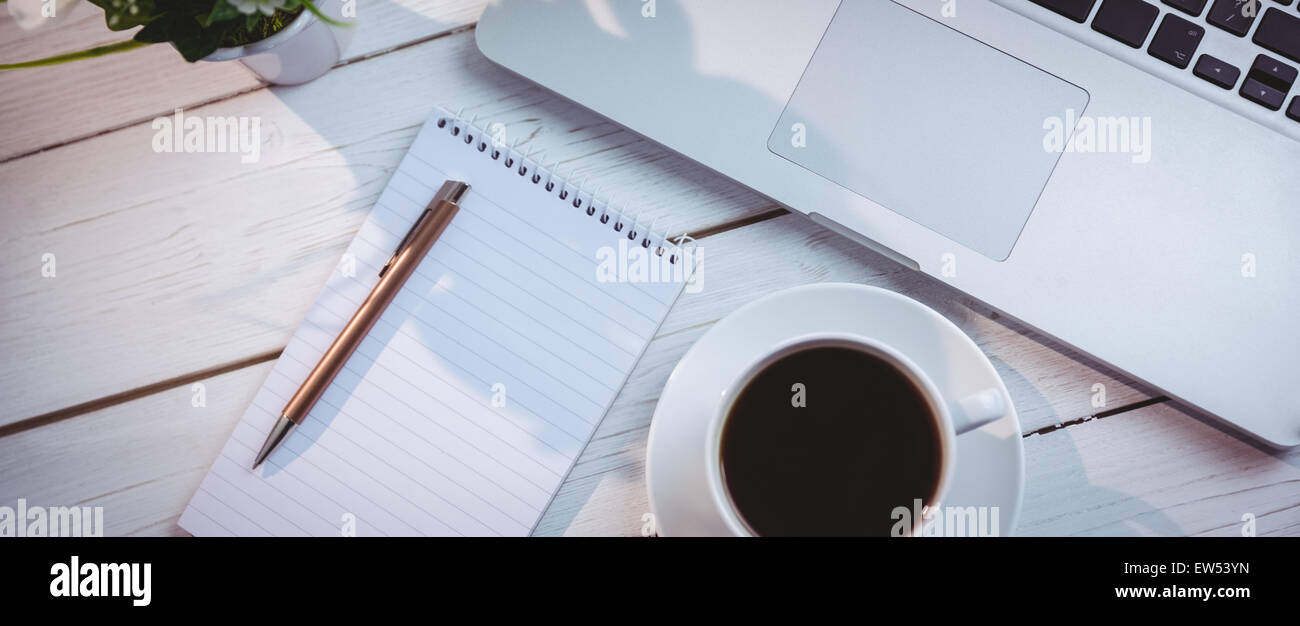 Overhead shot of laptop and notepad Stock Photo - Alamy