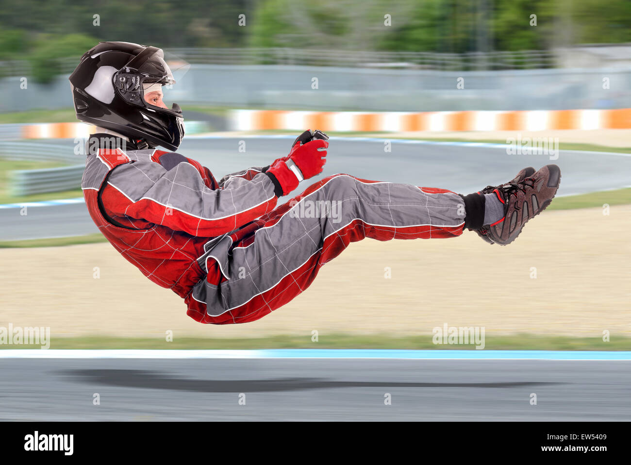 Racing driver on track in driving position in full gear Stock Photo - Alamy