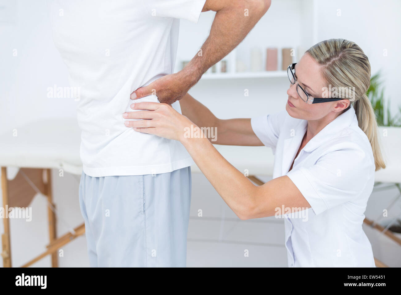 Doctor examining her patient back Stock Photo - Alamy