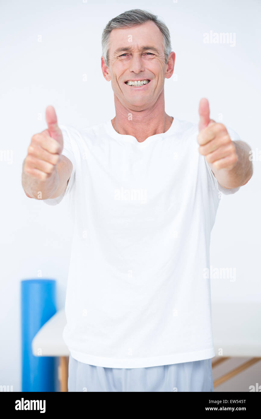 Happy patient looking at camera thumbs up Stock Photo - Alamy