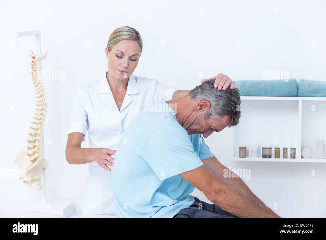 Doctor stretching a man back Stock Photo - Alamy
